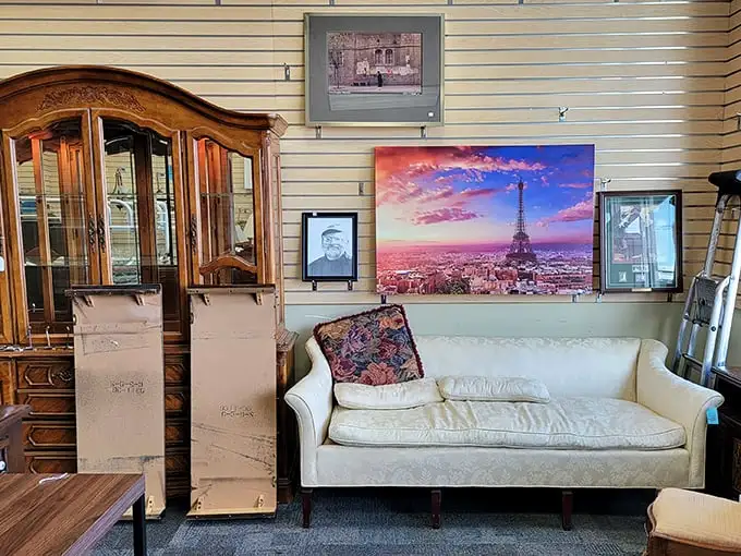 Mid-century modern meets Parisian dreams in this furniture vignette. That cream sofa has stories to tell—and at thrift store prices, you can afford to listen.