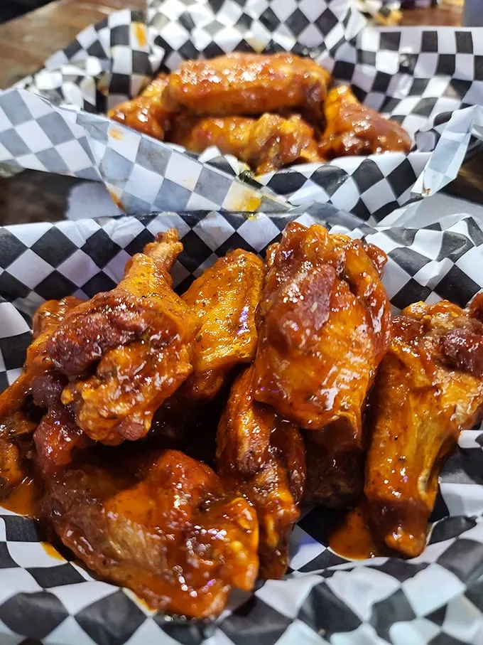 These wings aren't just sauced—they're baptized. The checkered paper basket barely contains the glory of what might be Virginia's most authentic Buffalo experience.