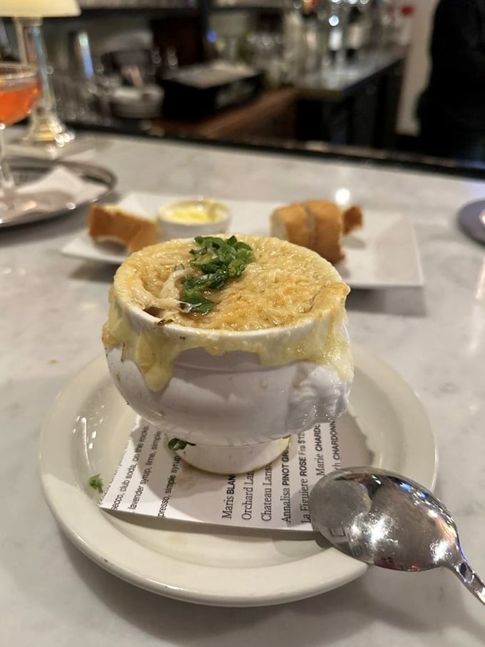 Behold, the Holy Grail of soups! This French onion masterpiece is more layers than an onion-themed soap opera.