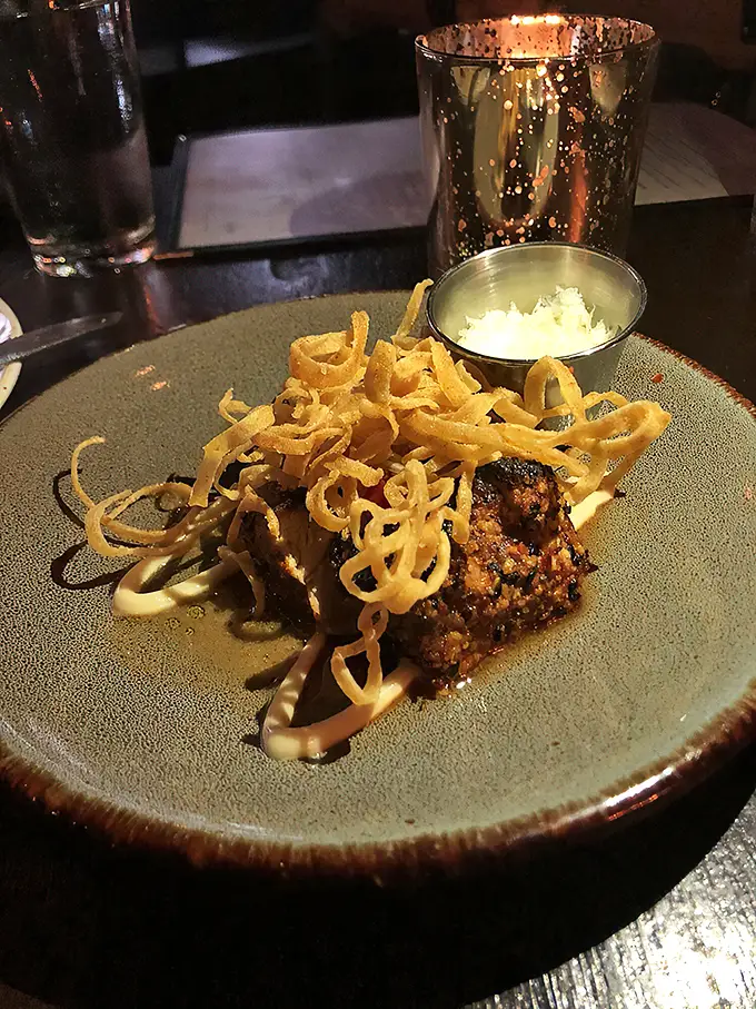 This isn't just food; it's edible art—where crispy garnishes dance atop a perfectly seared medallion that deserves its own gallery opening.