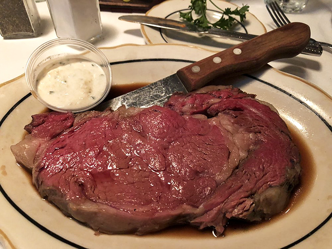 The prime rib arrives like a celebrity—commanding attention, perfectly dressed, and absolutely worth the wait for an audience.