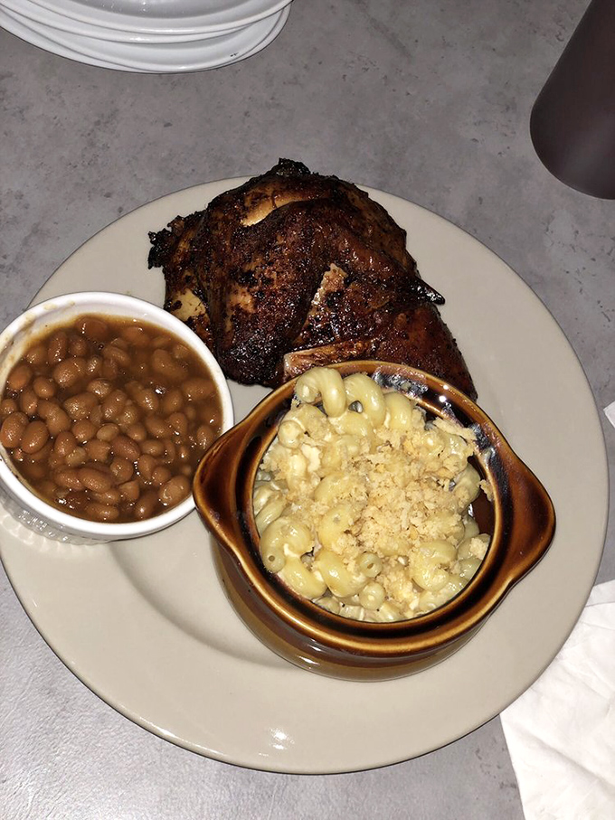 This plate tells the whole story – smoky chicken with a perfect bark, baked beans that didn't come from any can, and mac and cheese that deserves its own fan club.