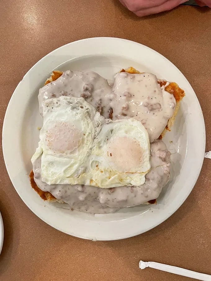 Biscuits and gravy with sunny-side-up eggs—the breakfast equivalent of a warm hug from your favorite grandparent. Comfort food perfection on a plate.