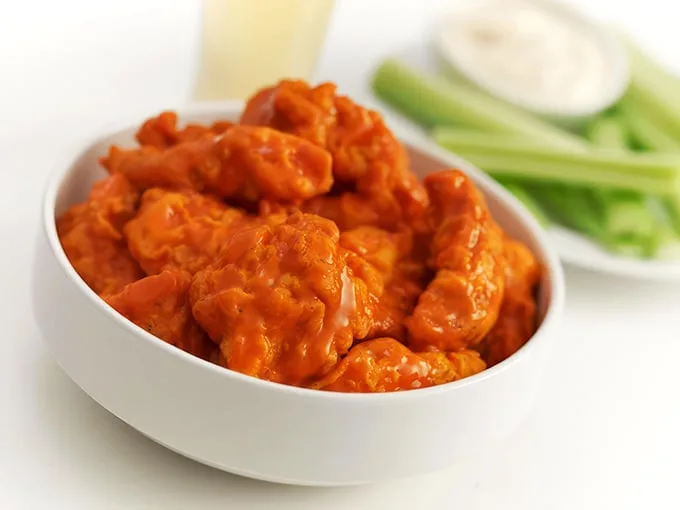 These buffalo wings aren't just orange; they're practically glowing with flavor potential, waiting to transform your ordinary Tuesday into something memorable.