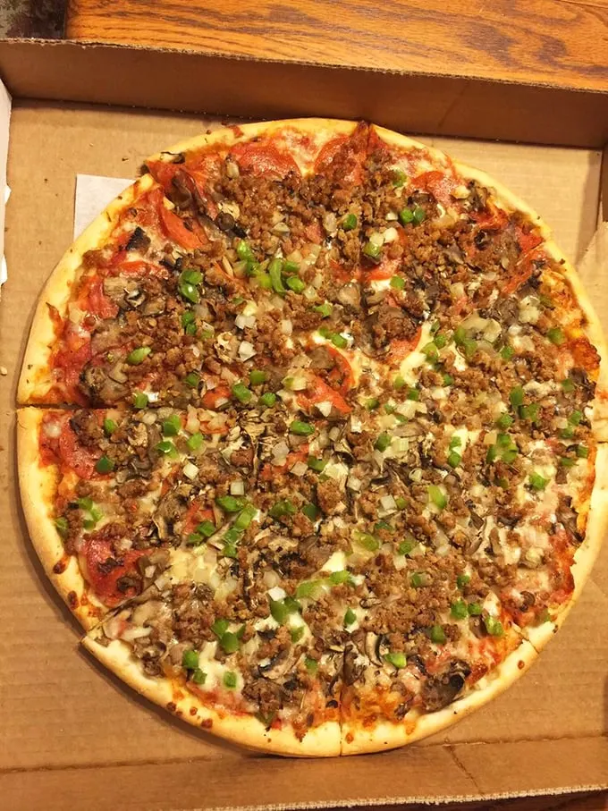 Holy moly, it's a flavor explosion! This pizza's got more toppings than a sundae bar at a kid's birthday party.