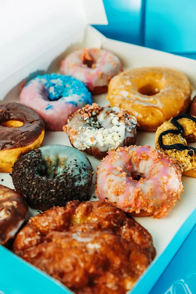 A dozen reasons to smile! This box of donuts is more colorful than a Hawaiian shirt convention.