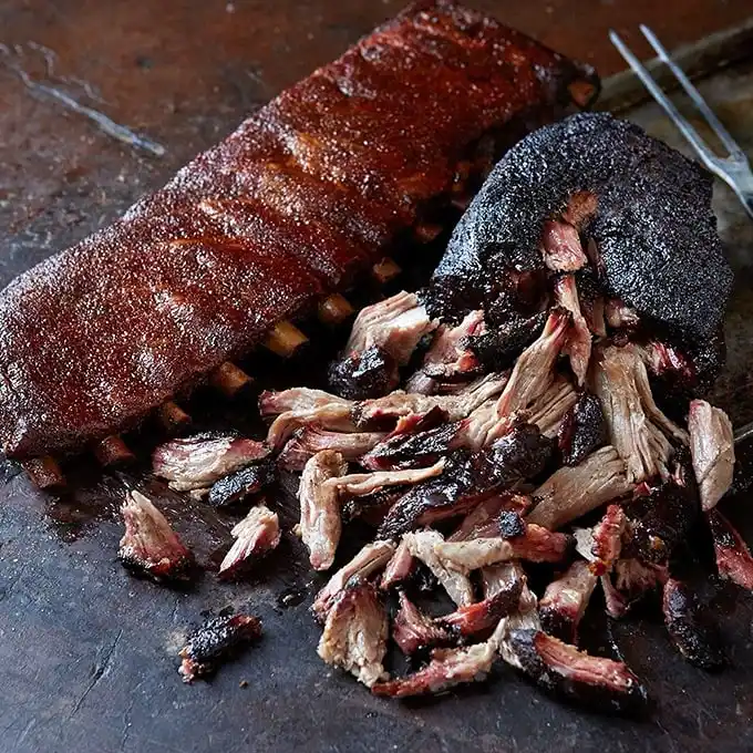 Behold the transformation of humble pork into edible art. That bark is the barbecue equivalent of a Rolex—showing off craftsmanship and patience.
