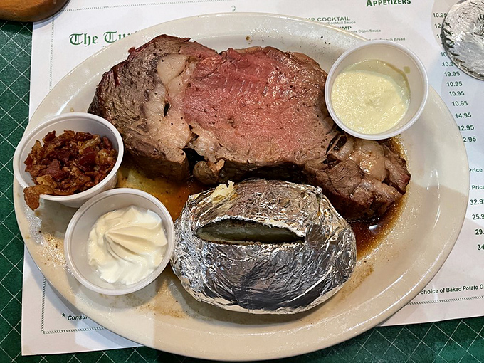 Prime rib perfection on a plate! This juicy masterpiece comes with a baked potato so big, it could have its own ZIP code.