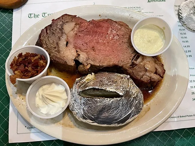 Prime rib perfection on a plate! This juicy masterpiece comes with a baked potato so big, it could have its own ZIP code.