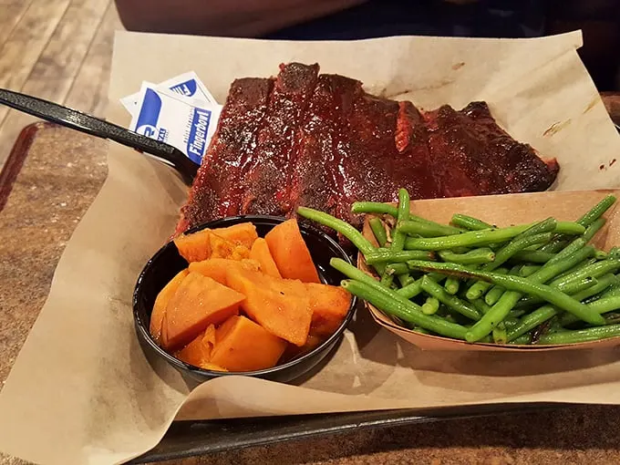 The holy trinity of BBQ bliss! A rack of ribs, golden corn on the cob, and crispy fries – a meal fit for a king.