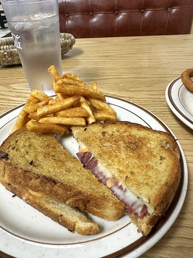 Holy cow, that's a sandwich! This Reuben is stacked higher than Elvis's pompadour. Corned beef, sauerkraut, and melty cheese – a deli lover's dream.