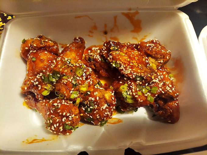 Sesame-crusted flavor bombs await! These wings are dressed to impress, like tiny poultry celebrities on a saucy red carpet.