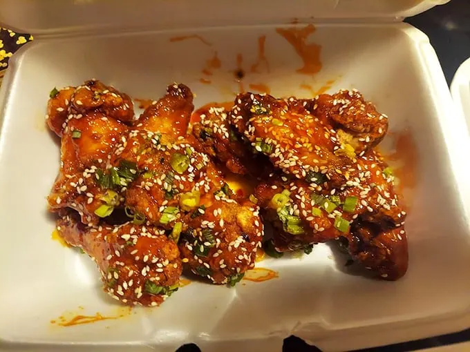 Sesame-crusted flavor bombs await! These wings are dressed to impress, like tiny poultry celebrities on a saucy red carpet.