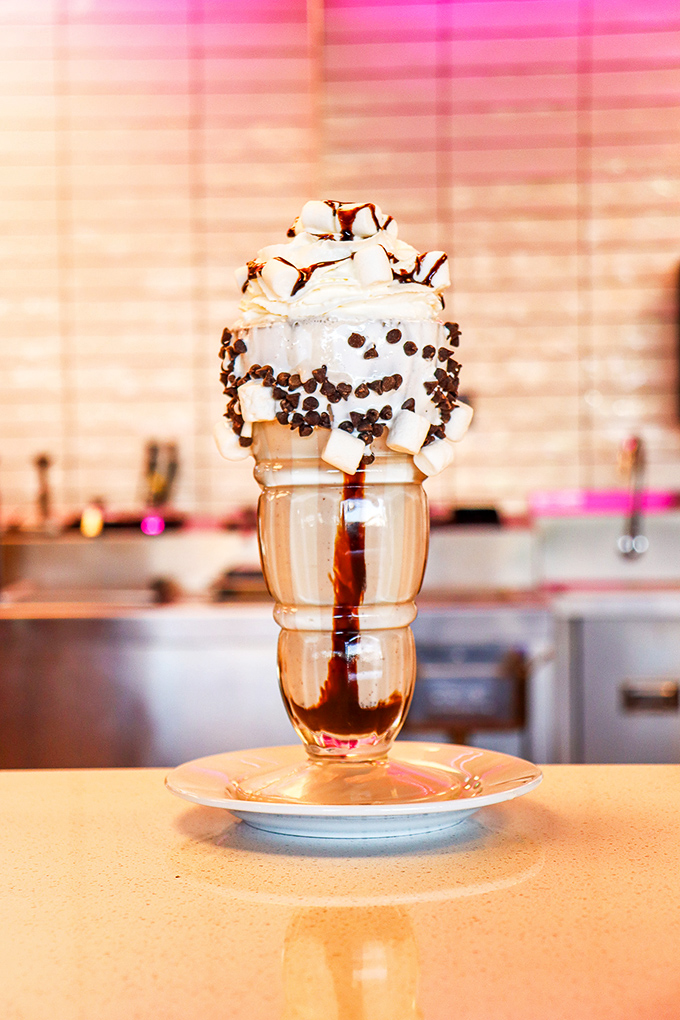 Holy moly, that's not a milkshake – it's a work of art! Topped with enough whipped cream to make a cloud jealous, this chocolatey masterpiece is pure bliss.