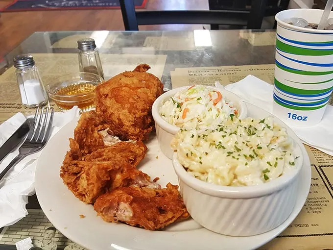 A plate that screams "cheat day"! Golden-fried chicken nestled next to creamy mac and cheese – it's like a hug for your taste buds.