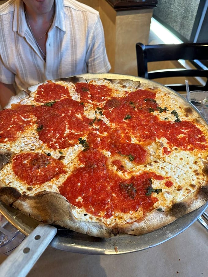 Simplicity at its finest! This Margherita pizza is so fresh, you'd think the basil was doing yoga on your plate.