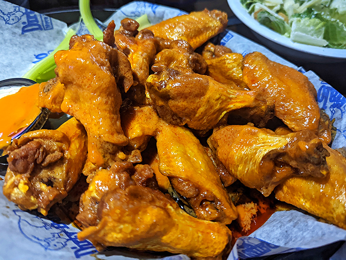 Orange-hued masterpieces that make you question why you ever bothered eating anything else. These wings don't just have heat—they have personality.