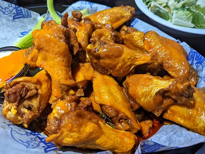 Orange-hued masterpieces that make you question why you ever bothered eating anything else. These wings don't just have heat—they have personality.