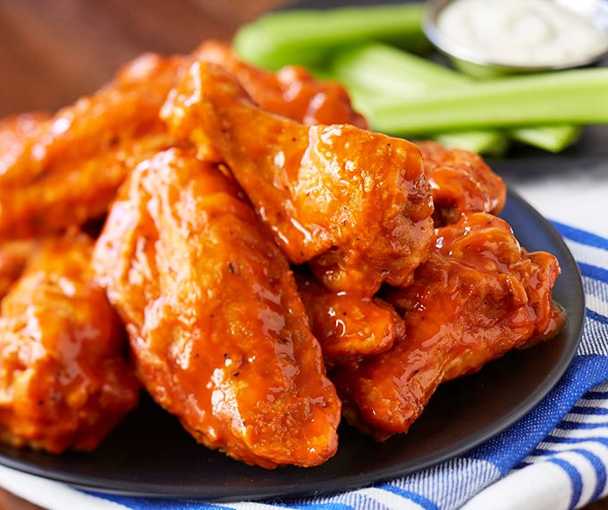 These wings aren't just hot, they're smokin'! Glossy, saucy, and ready to set your taste buds ablaze.