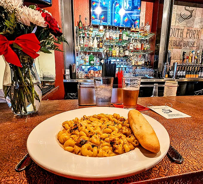 A plate of South Fork's iconic mac and cheese awaits at the bar—proof that sometimes the simplest pleasures create the most profound memories.