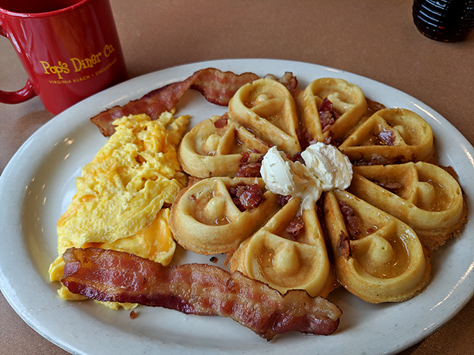 These waffles aren't just breakfast, they're architecture—golden buttermilk cathedrals topped with bacon and perfectly scrambled eggs. The holy trinity of morning meals.