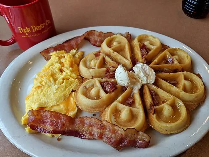 These waffles aren't just breakfast, they're architecture—golden buttermilk cathedrals topped with bacon and perfectly scrambled eggs. The holy trinity of morning meals.