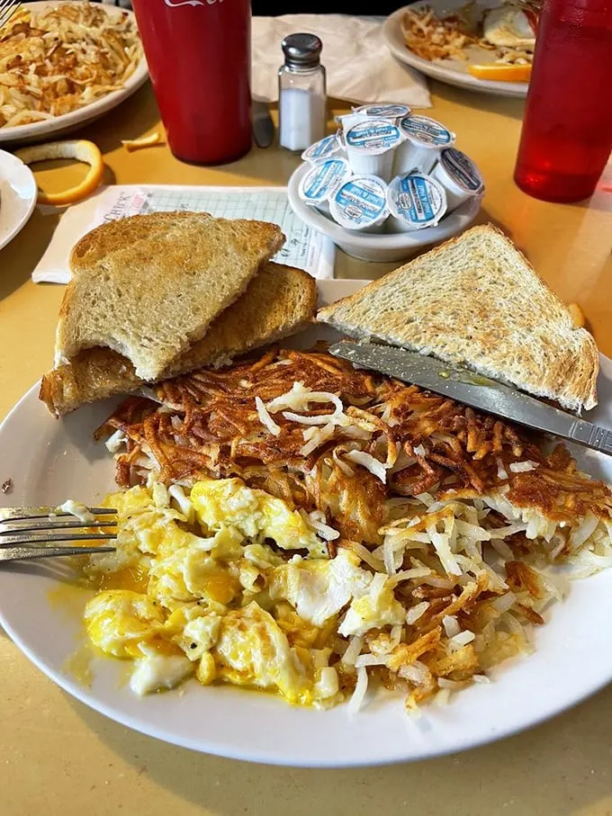 Breakfast of champions, or anyone who appreciates a plate that's more "yes" than "yolk." Eggs, hash browns, and toast – the holy trinity of morning indulgence.
