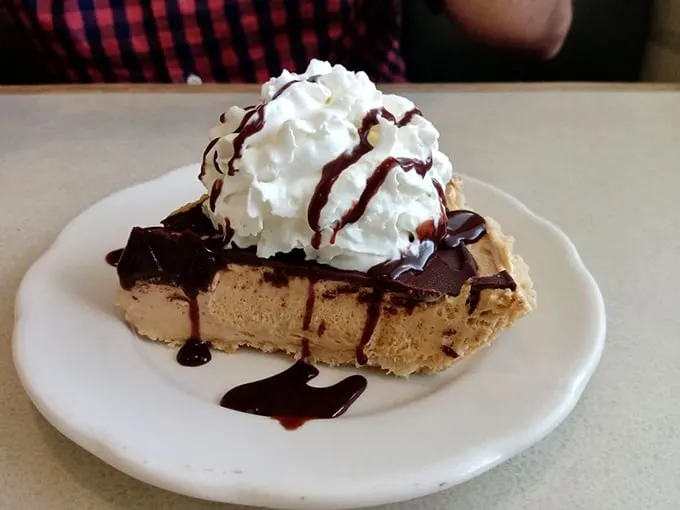 Peanut butter lovers, rejoice! This pie is like a Reese's cup got a PhD in deliciousness. Creamy, dreamy, and topped with a cloud of whipped cream – resistance is futile.
