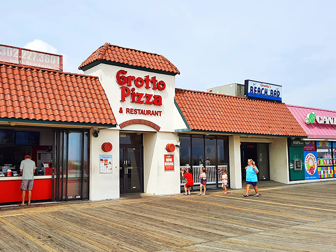 Grotto Pizza on the boardwalk—where the spiral of sauce meets the spiral of life, and vacation memories are served by the slice.