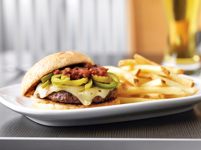 This isn't just a burger – it's an architectural achievement of beef, cheese, and jalapeños that requires both hands and possibly a bib.
