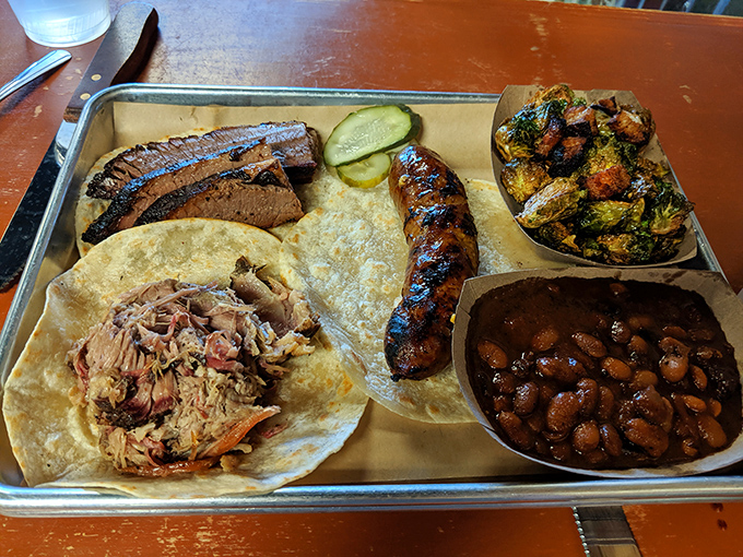 A plate so diverse, it could run for office! Brisket, kielbasa, Brussels sprouts, and beans – the United Nations of BBQ.