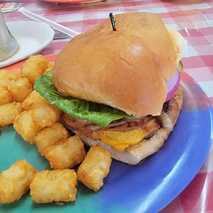 Now that's a burger! Juicy, stacked, and ready to challenge your jaw's flexibility. Napkins are not just suggested – they're a survival tool.