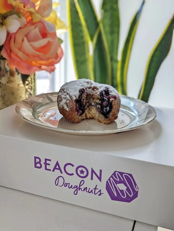 Blueberry bliss in every bite! This donut looks like it could tell you the secrets of the universe... if you listen closely enough.
