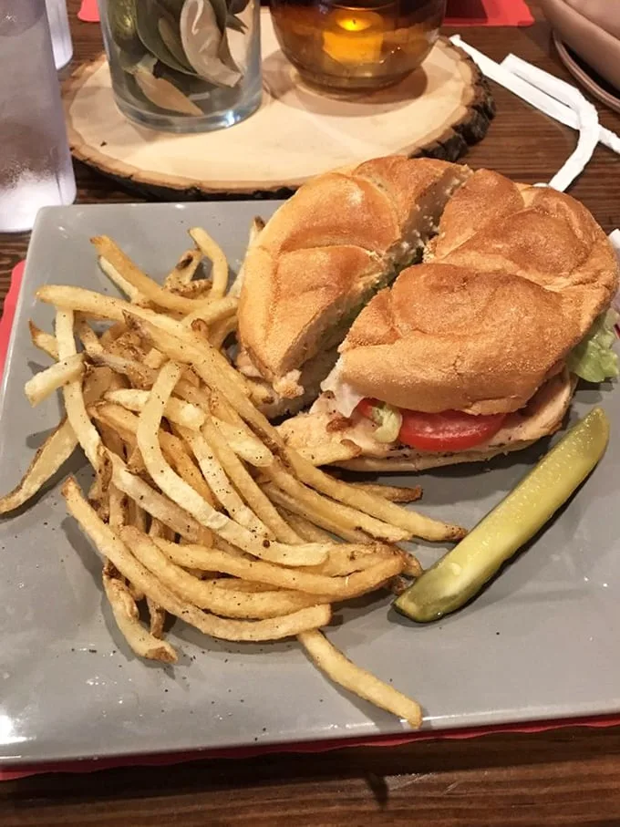This sandwich isn't trying to impress Instagram—it's trying to impress your taste buds. Crispy fries and a pickle complete this lunch that screams "naptime afterward."