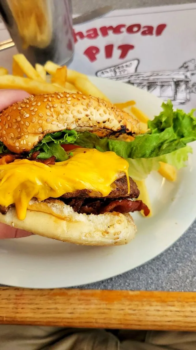 Behold the Summit Burger in all its glory! This cheese-draped beauty is ready for its close-up – and your taste buds are ready for true love.