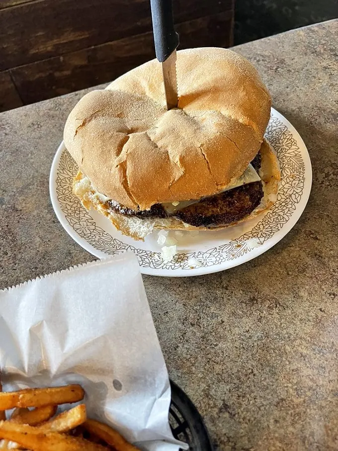 A burger so good, it deserves its own entourage. Those fries aren't just a side dish, they're loyal supporters in this culinary concert.