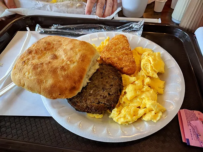 Breakfast of champions! This plate is a morning masterpiece – golden biscuit, savory sausage, and eggs sunny enough to brighten your day.