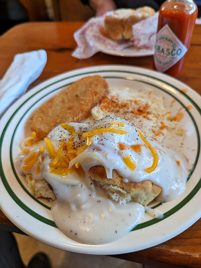 Breakfast perfection on a plate: fluffy biscuits, creamy gravy, and enough cheese to make a mouse swoon. Diets, beware – resistance is futile!
