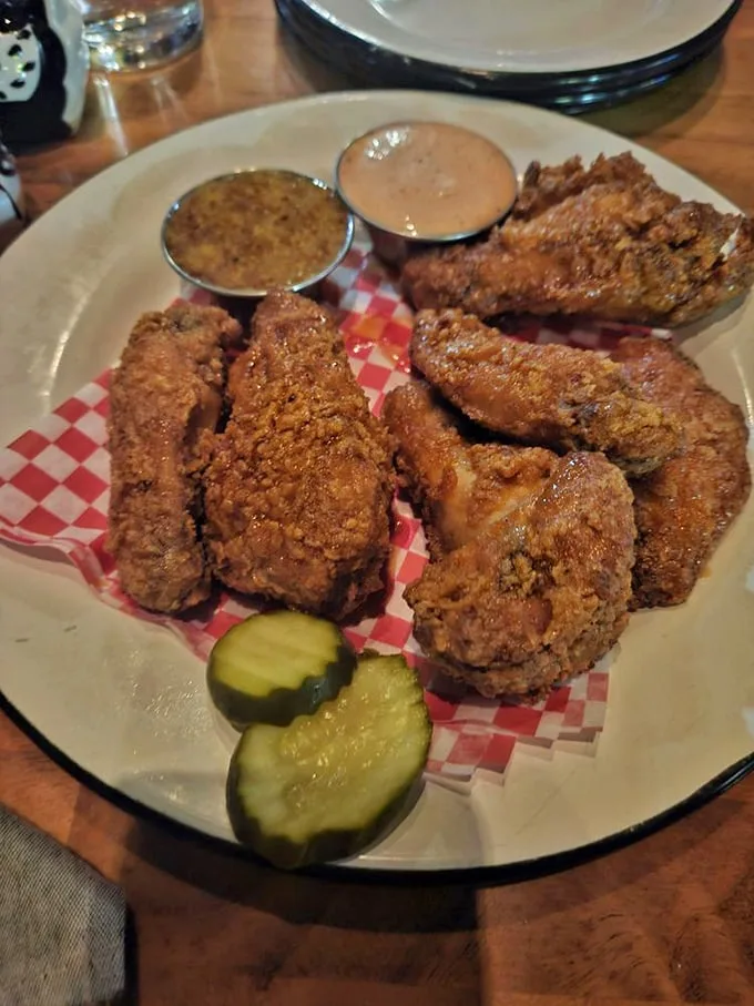 Wings that demand to be photographed before being devoured. The pickle slice isn't just garnish—it's the acid counterpoint to all that glorious richness.