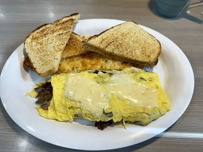 This omelet is cheesier than my dad's jokes, and those hash browns are crispier than my grandma's wit. Breakfast perfection!