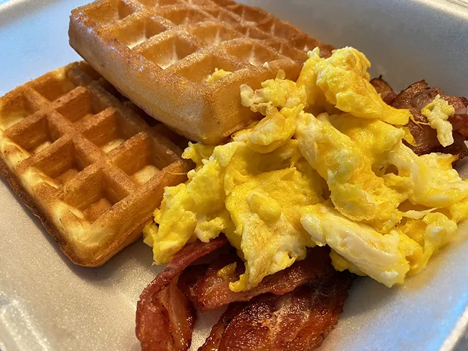 Waffles, eggs, and bacon—oh my! This plate is like the Wizard of Oz for your taste buds.