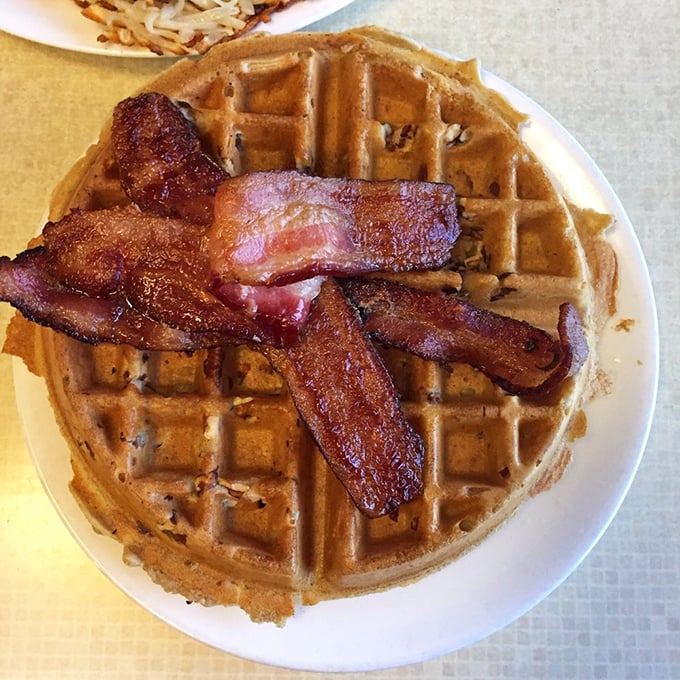 A breakfast spread that could make even Garfield excited about mornings. Waffles, bacon, and hash browns – the holy trinity of AM indulgence.