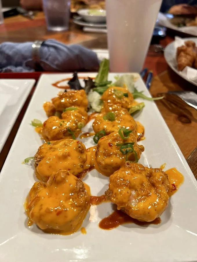 These aren't just boneless wings—they're flavor vehicles delivering saucy satisfaction with every bite. The garnish is just there to make you feel virtuous.