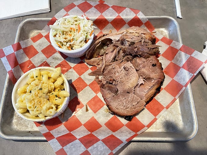 A metal tray of brisket, slaw, and that famous mac and cheese – the holy trinity of comfort that makes you want to hug the chef.