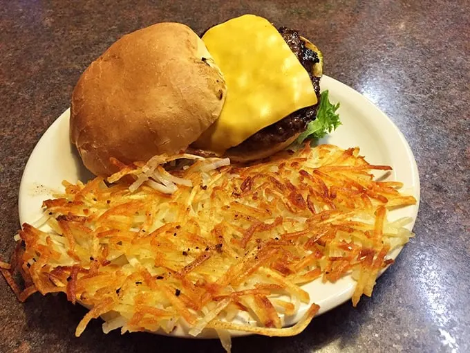 This burger's got more layers than a Nebraska winter wardrobe. Paired with those crispy hash browns, it's a dynamic duo of deliciousness.