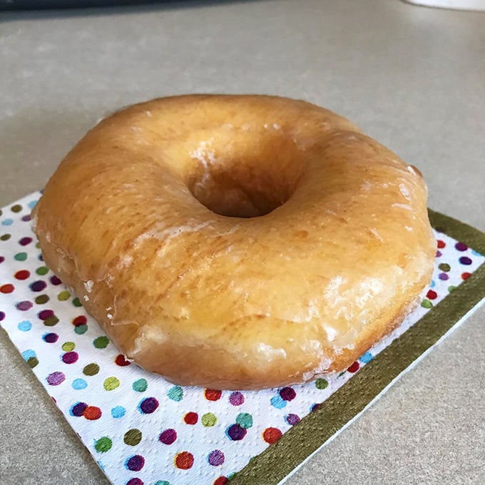 Simple perfection on a polka-dot napkin. This glazed doughnut is the little black dress of the pastry world – timeless, elegant, and always in style.