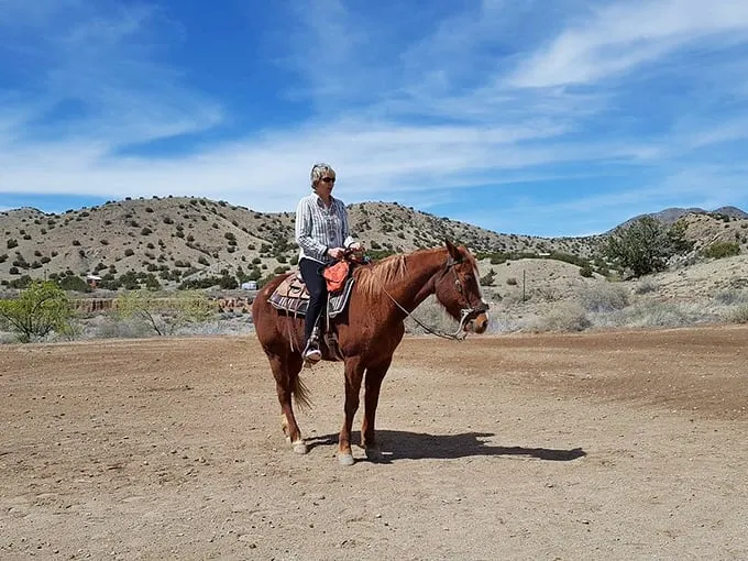 Giddy up, partner! This cowgirl's not just horsing around – she's living the authentic Wild West dream, minus the shootouts.