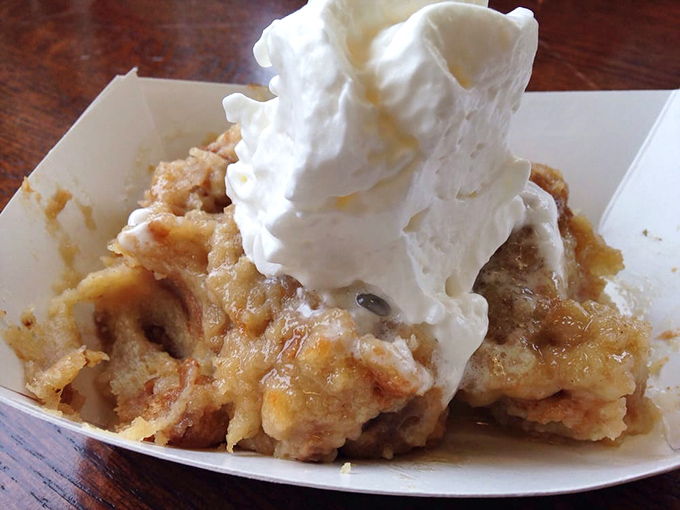 Bread pudding that could make your grandmother jealous. That mountain of whipped cream isn't excessive—it's essential infrastructure.