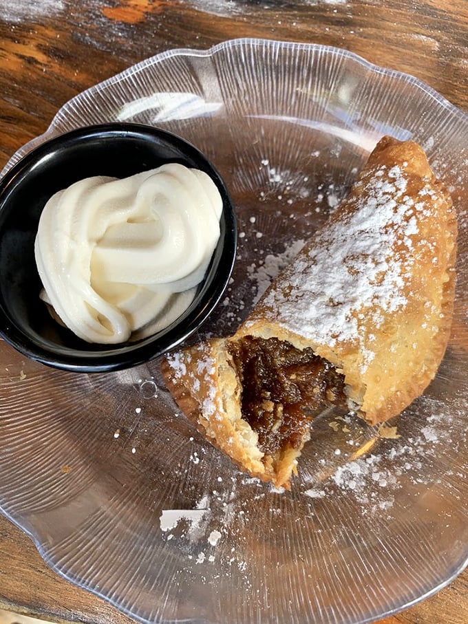 This isn't just dessert—it's a fried pecan pie with a cloud of whipped cream that makes you question why you've wasted calories on lesser sweets.