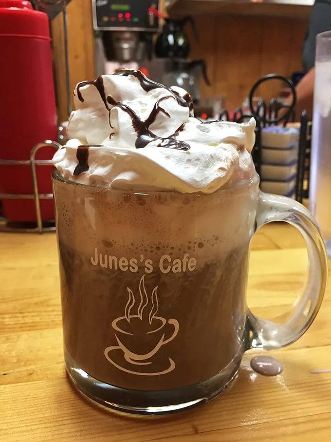 Hot chocolate elevated to an art form – a mountain of whipped cream drizzled with chocolate that makes you question why anyone drinks plain coffee.